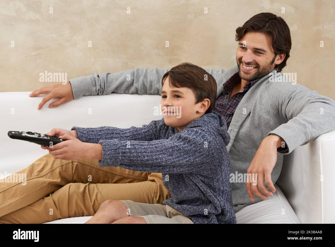 Watching some television with Dad. father and son enjoying some quality ...