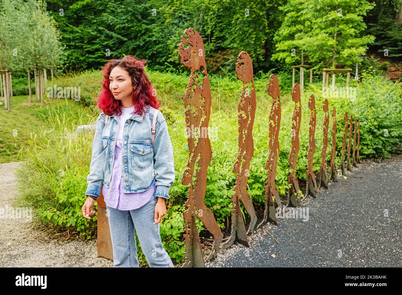 Funny modern homo sapiens girl in a row of prehistoric ancestors on a ...