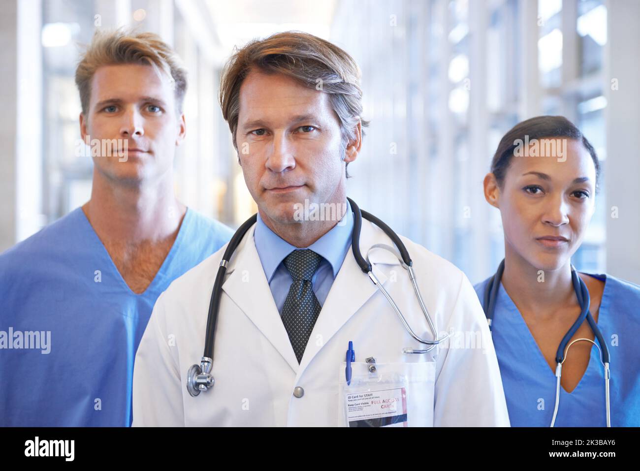 His medical team relies on his experience. A medical team standing in the hospital corridor ...