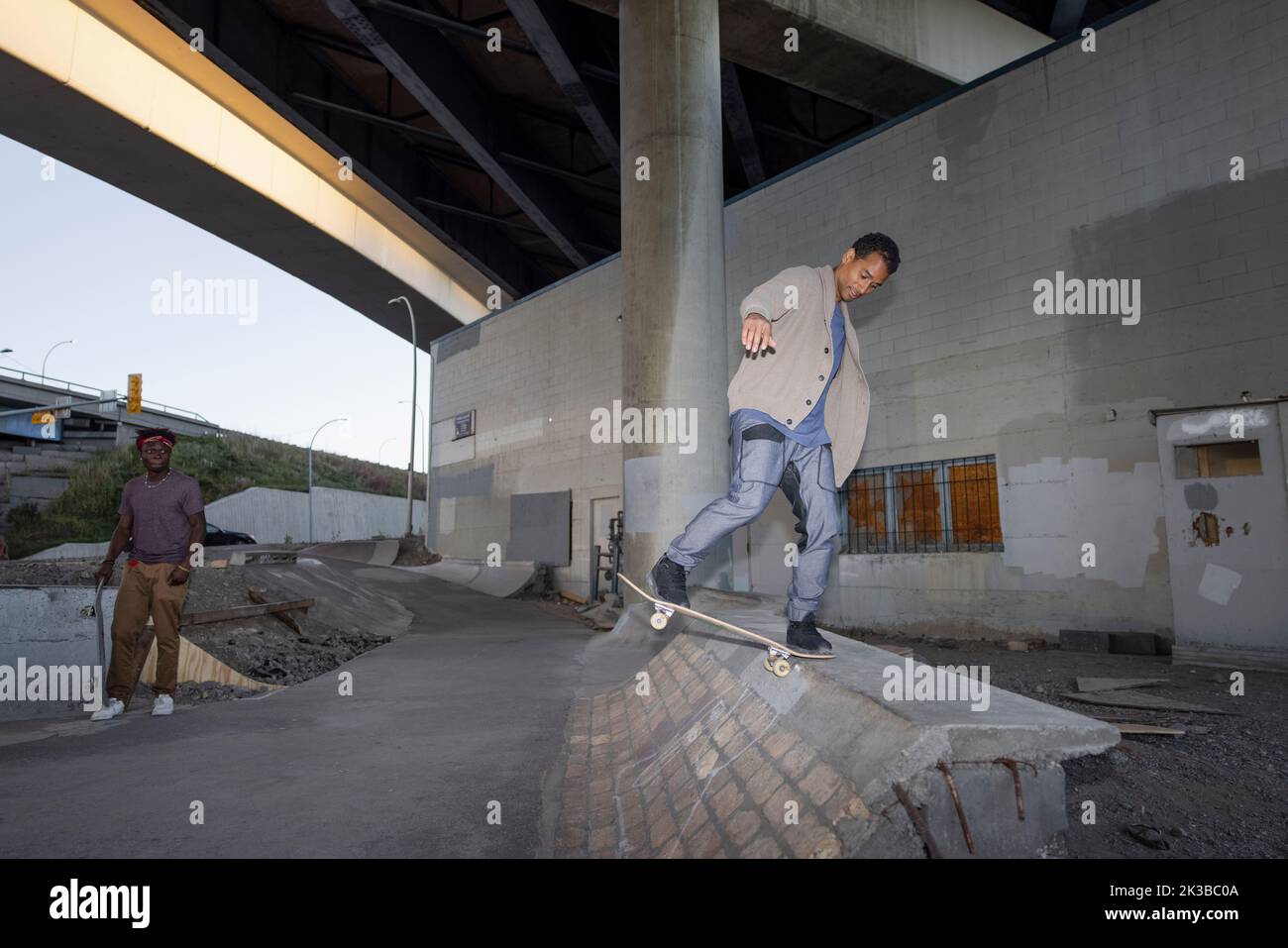 Man skateboarding on construction site under flyover Stock Photo - Alamy