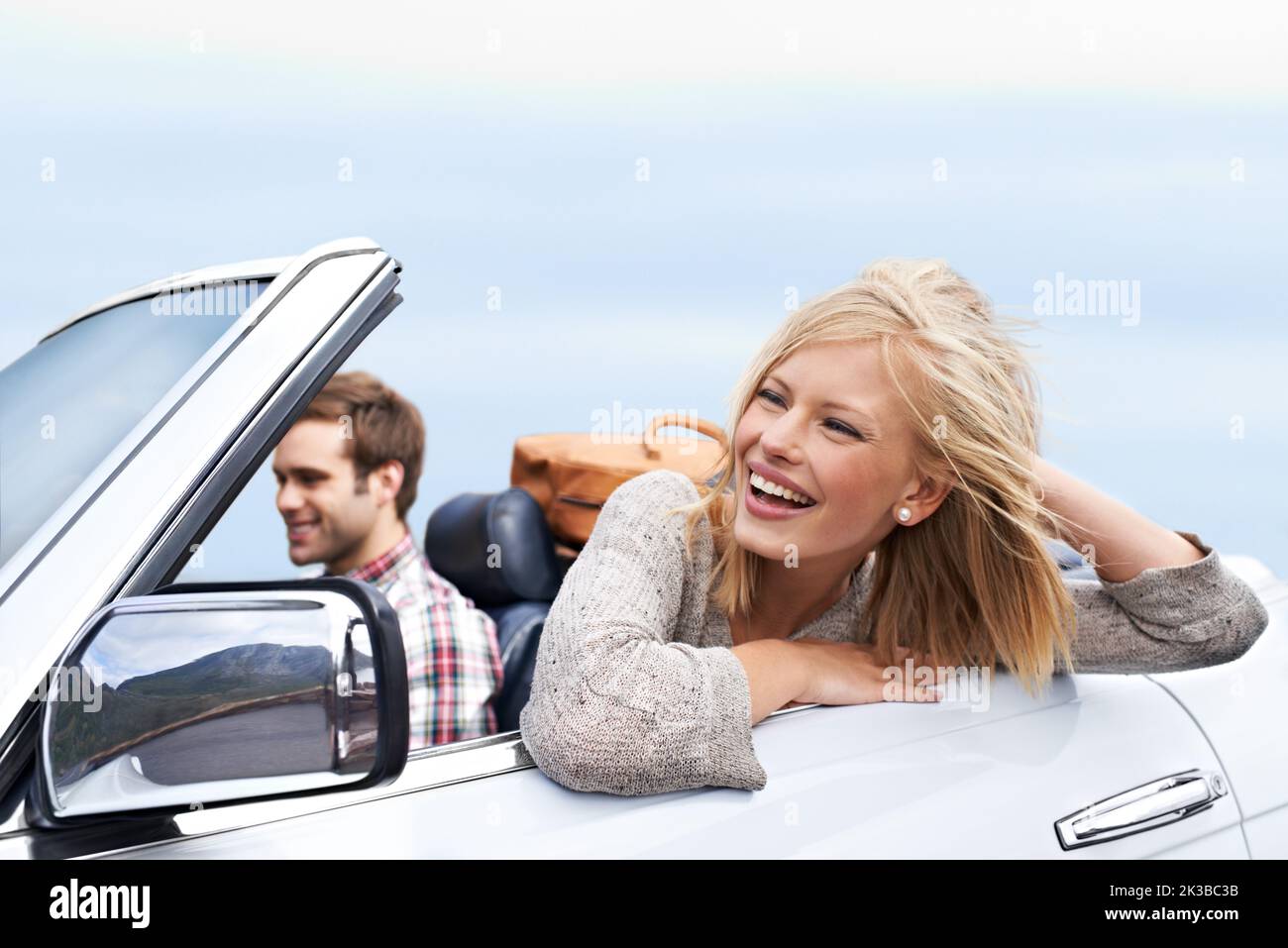 They love roadtrips. a young couple enjoying a drive in a convertible ...