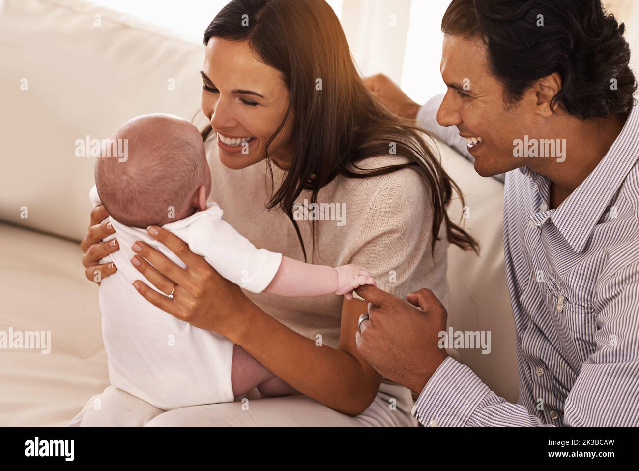 And baby makes three. an affectionate couple and their newborn baby ...