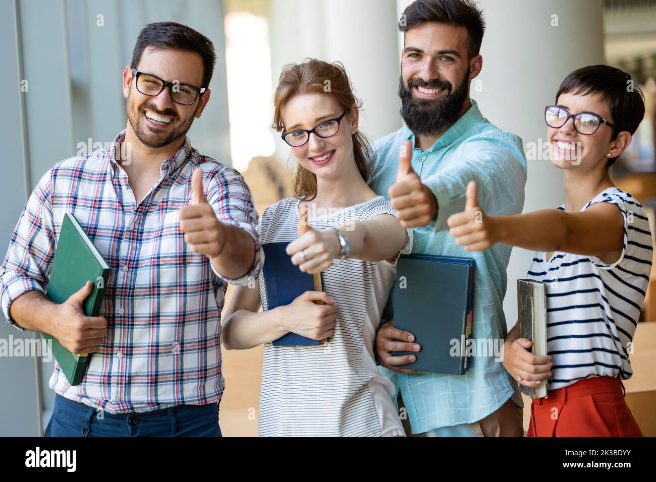 Happy group of students studying and working together in a college ...