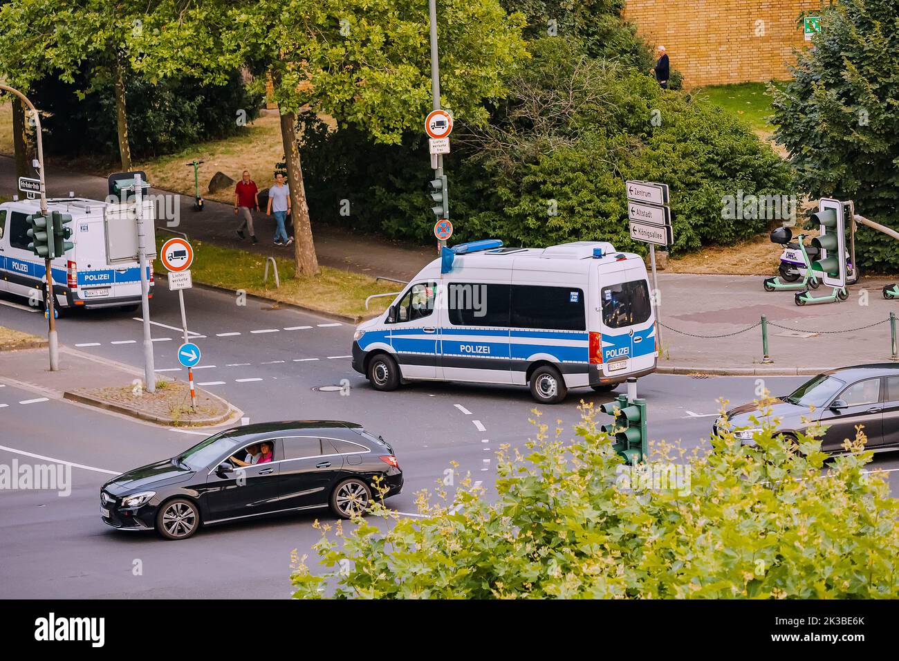 22 July 2022, Dusseldorf, Germany: Police minivans rushin on city ...