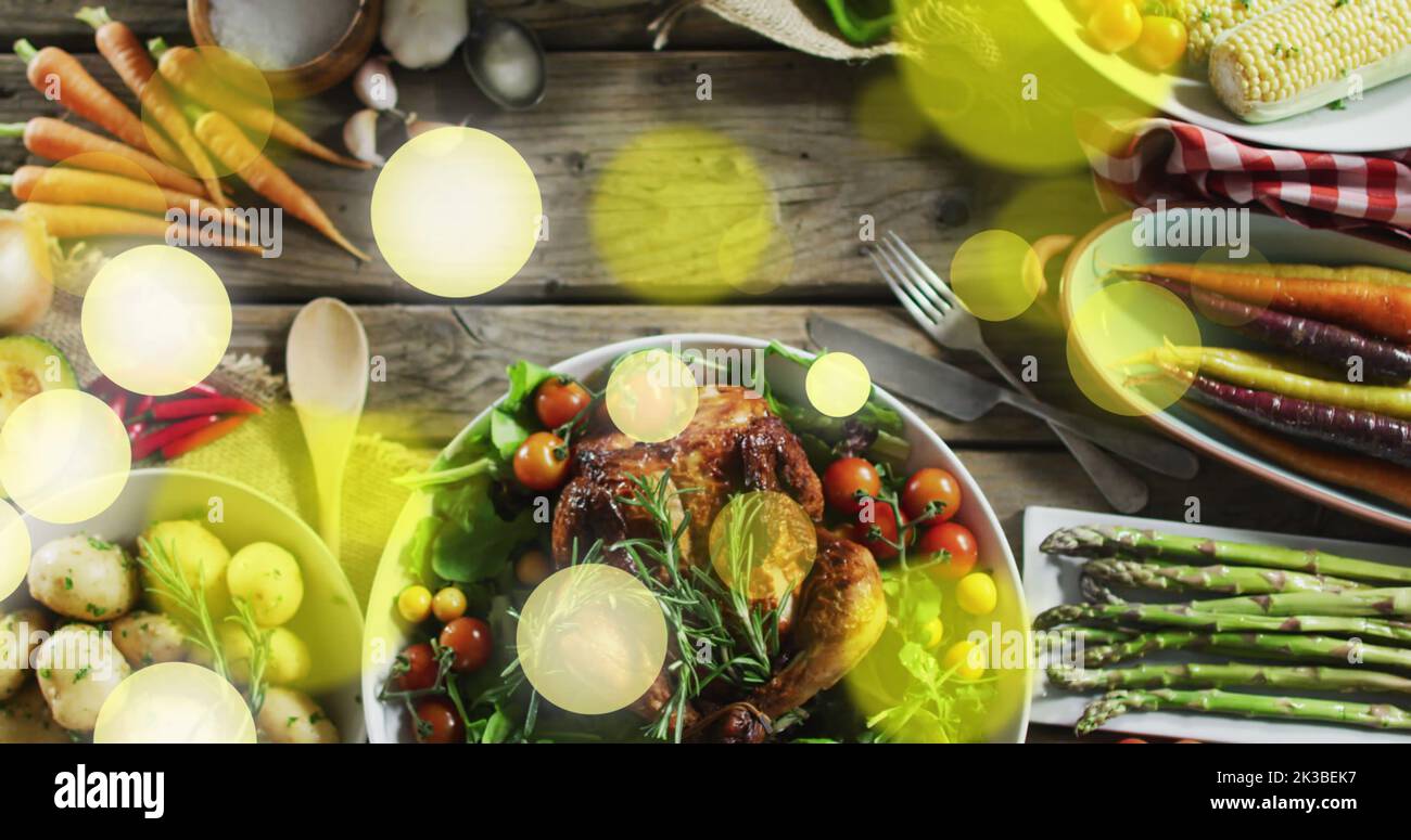 Image of light spots over plates with food on wooden background Stock ...