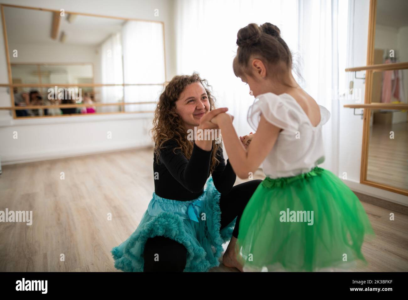 Little dissabled girl learning ballet with dance lecteur in ballet ...