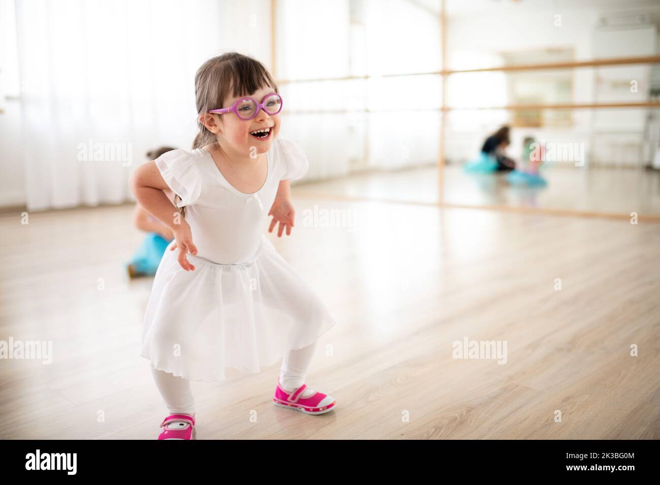 Little girl with down syndrome at ballet class in dance studio. Concept ...