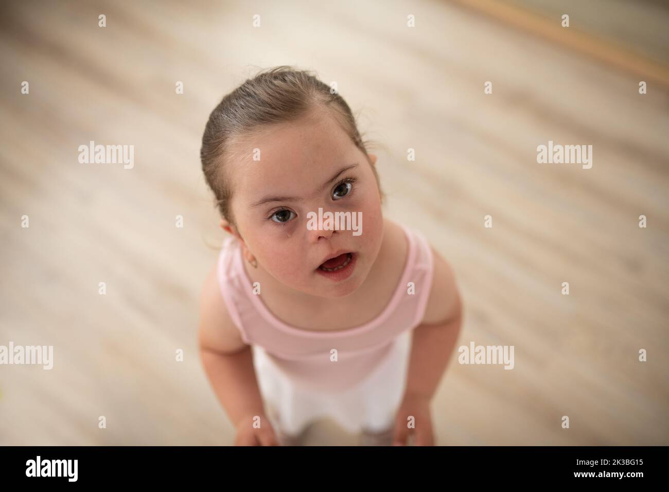 High angle view of little girl with down syndrome at ballet class in ...