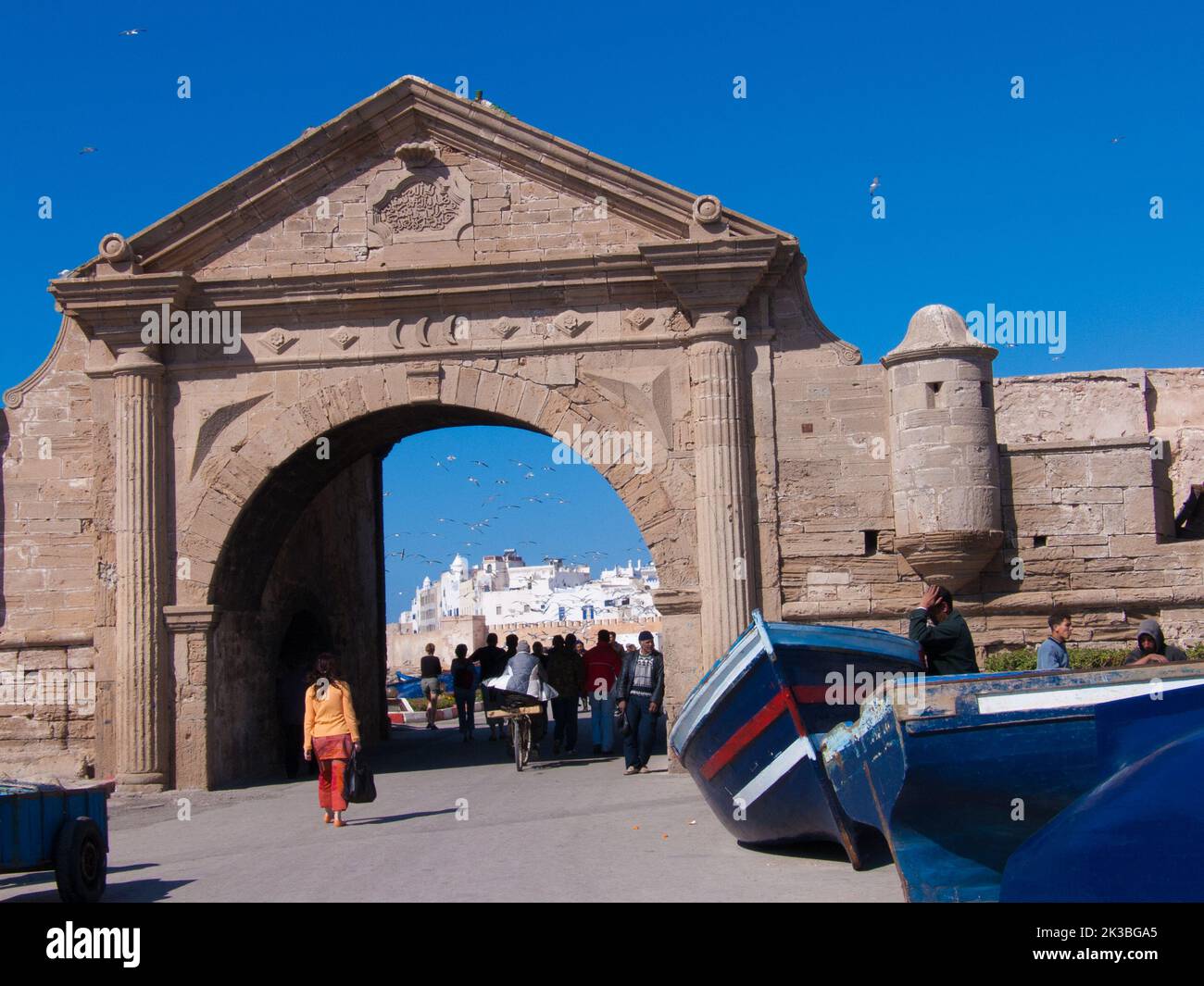 An aerial view of Bab el-Marsa gateway with walking people in Essaouira ...