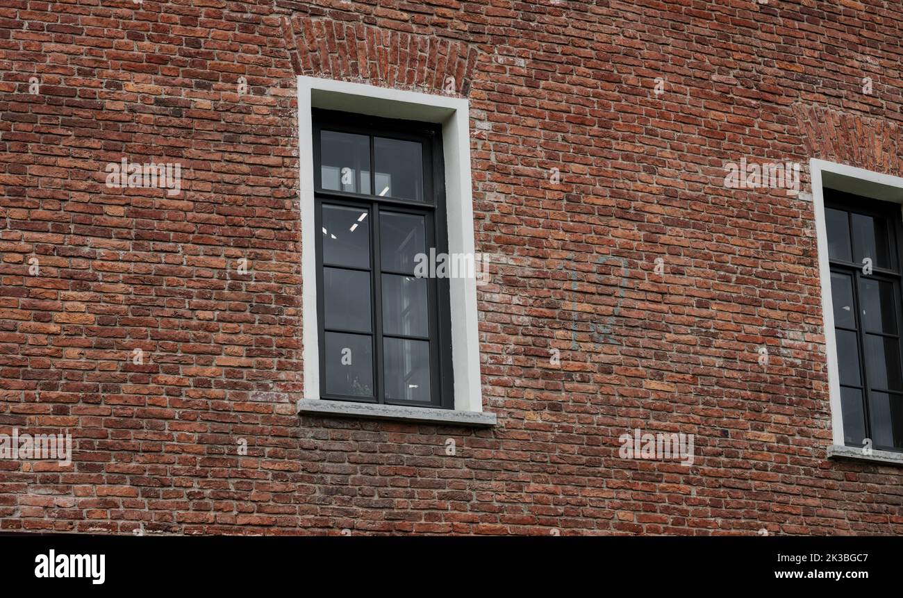 glass windows on brick wall of vintage house building. the facade of a ...