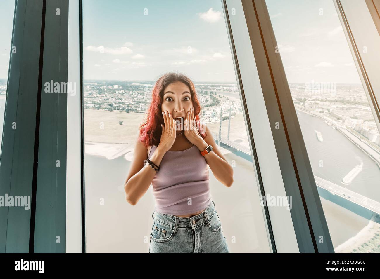 A girl with a phobia and fear of heights screams and reacts emotionally ...