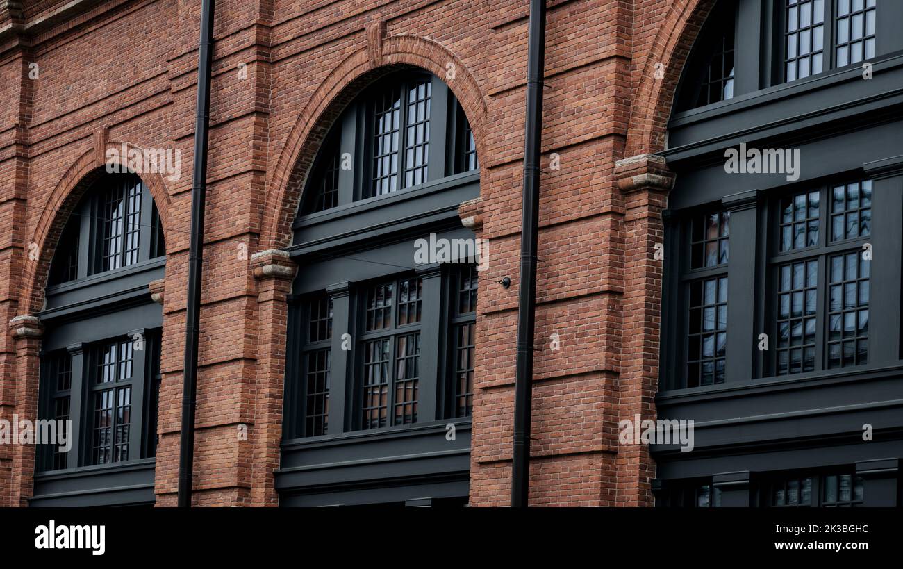 Modern brick facade. vintage windows on the factory red brick wall ...