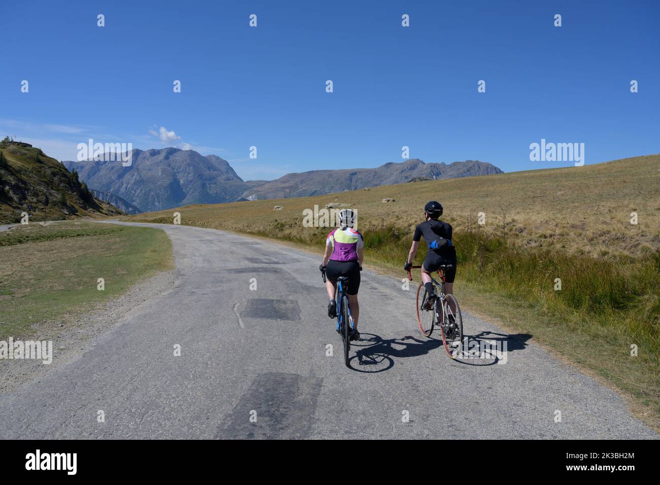Mother and son cycling on the Col de Sarenne, Grandes Rousses massif ...