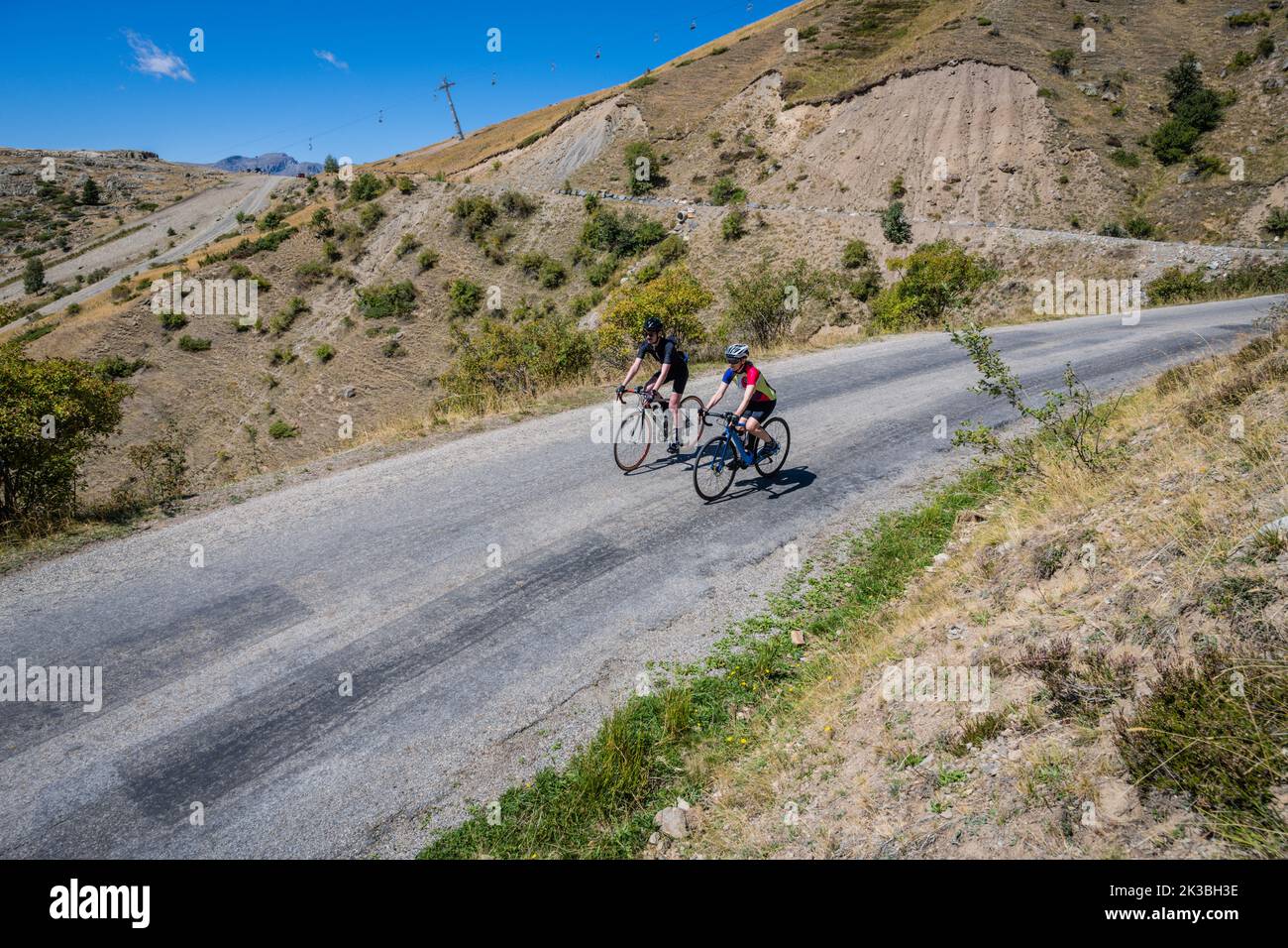 Mother and son cycling on the Col de Sarenne, Grandes Rousses massif ...