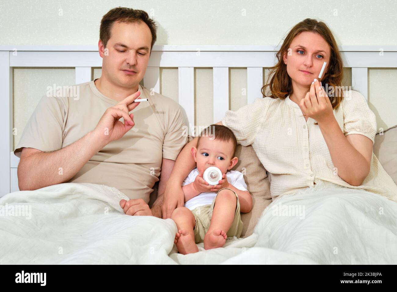 Mother and father thoughtfully look at cigarettes quitting smoking ...