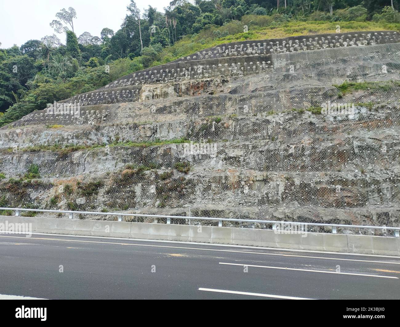 An aerial view road near soil nailing and concrete retaining wall in ...
