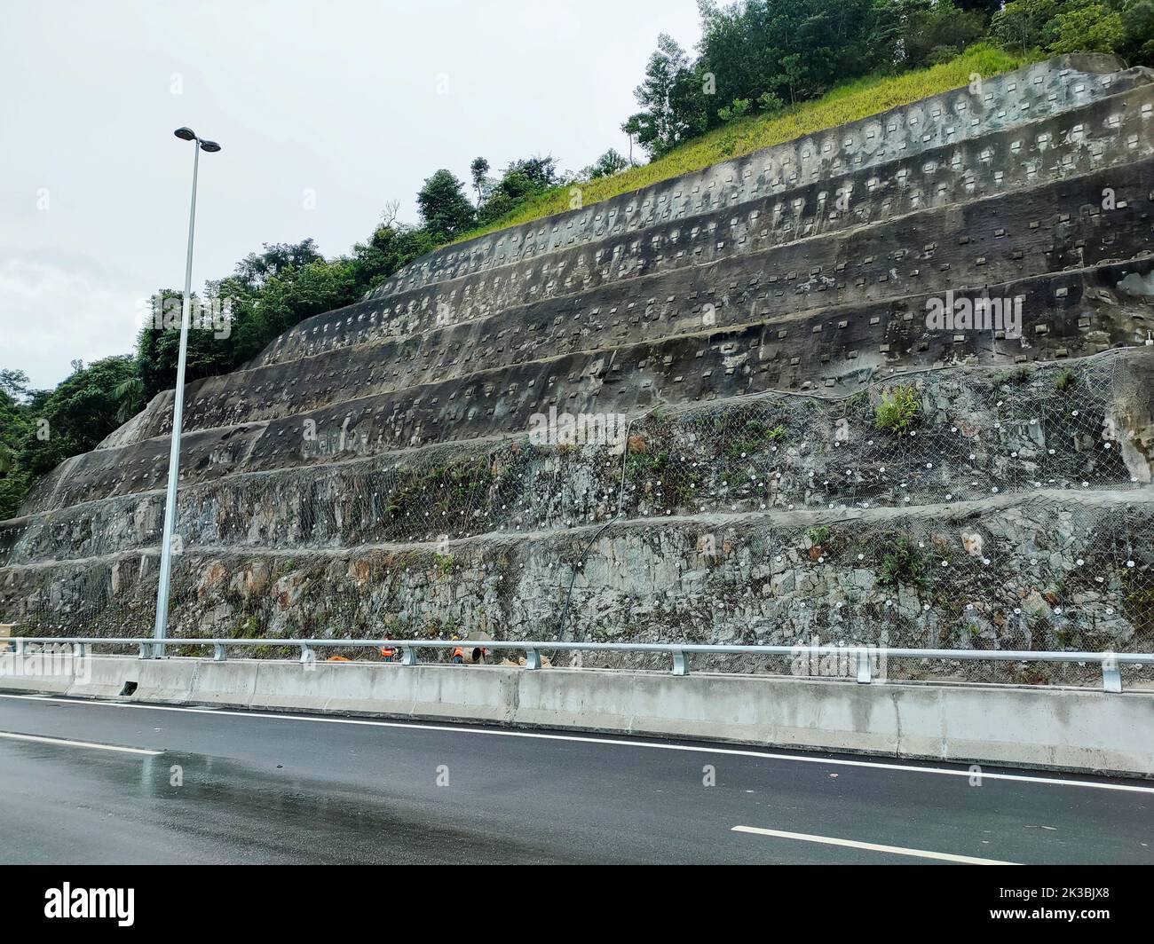An aerial view road near soil nailing and concrete retaining wall in ...