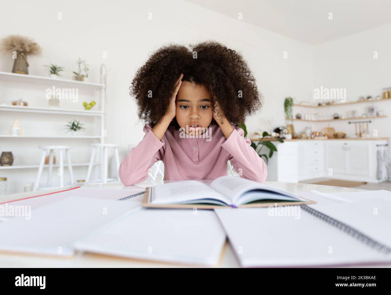 Overwhelmed african american school girl doing homework, feeling down ...