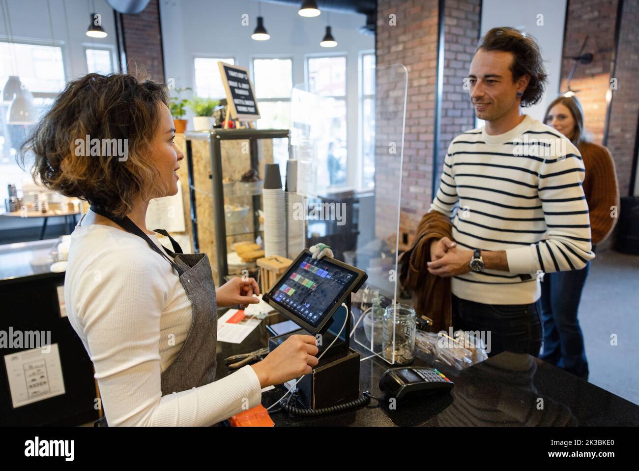 Barista behind cafe counter hi-res stock photography and images - Alamy