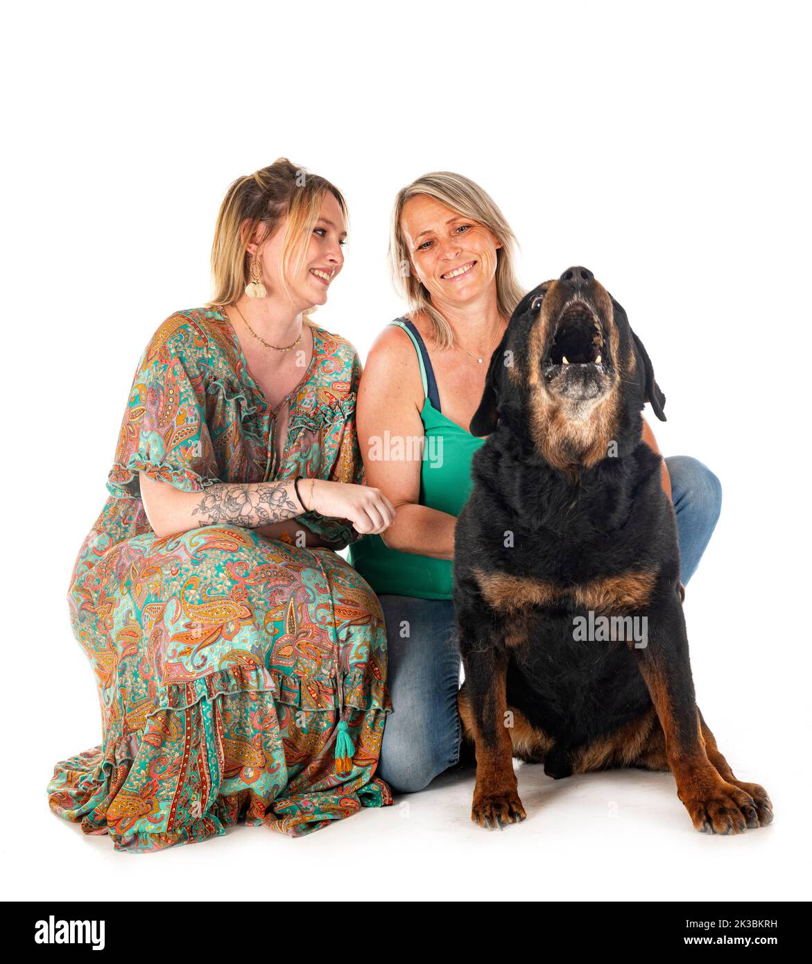 purebred old rottweiler fourteen year and his owners in front of white ...