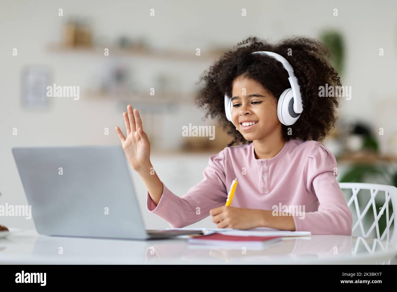Cheerful black school girl having online class, home interior Stock ...