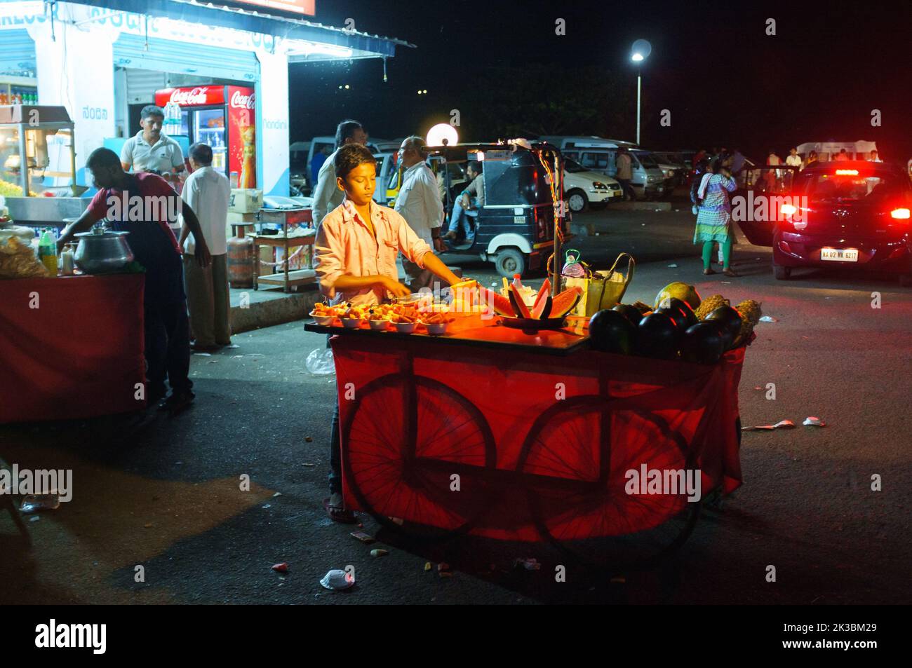 A young Indian boy selling fresh mangos in a street stand in Mysore ...