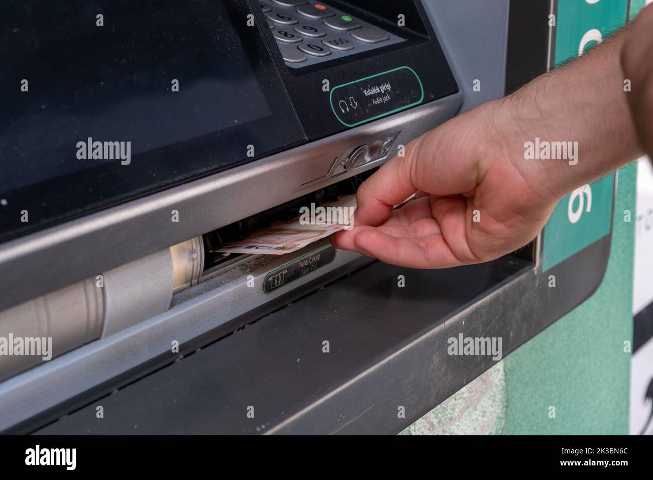 Man hand withdrawing Turkish lira from atm machine, automatic teller machine with person hand ...