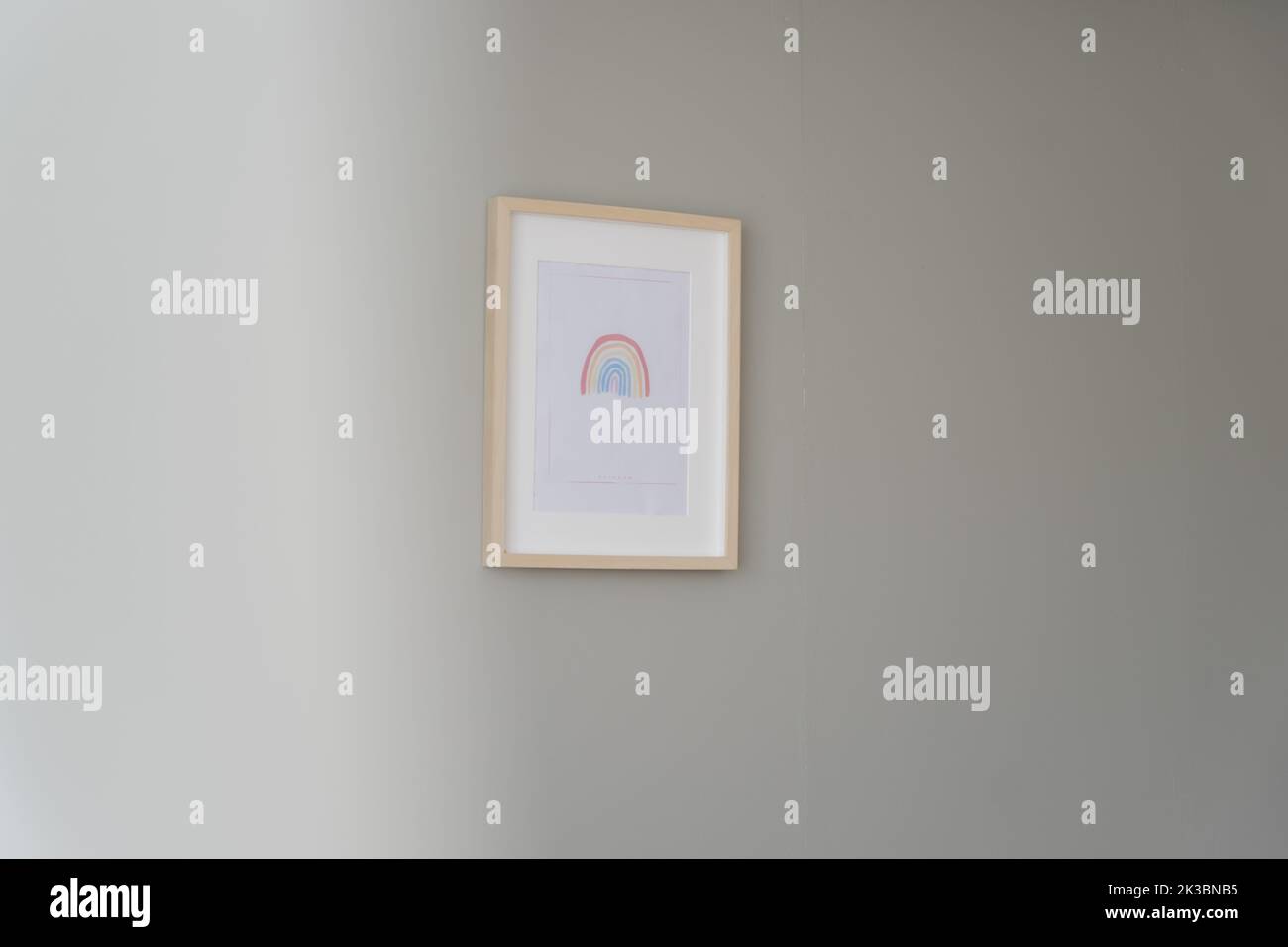 A framed rainbow poster hanging on a gray wall Stock Photo - Alamy