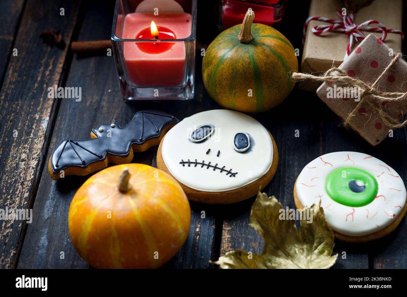 autumn composition with gingerbread for halloween, candles, pumpkins ...