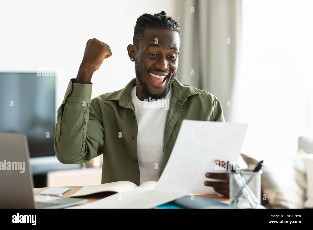 African man celebrating reading documents hi-res stock photography and ...