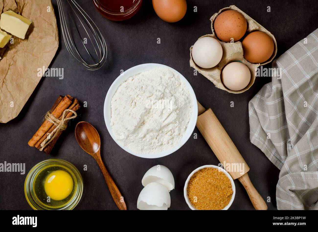 Top view of ingredients bakery making on dark old table. Flour, eggs ...