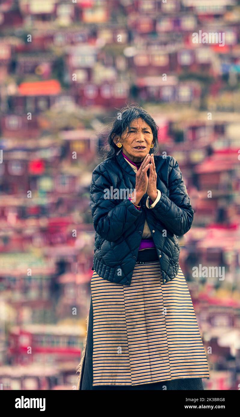 An old woman during her Buddhist pray in a temple, Tibet Stock Photo ...