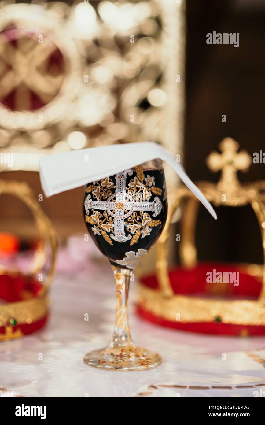 A vertical shot of an ornament wine glass with cross designed on it and ...