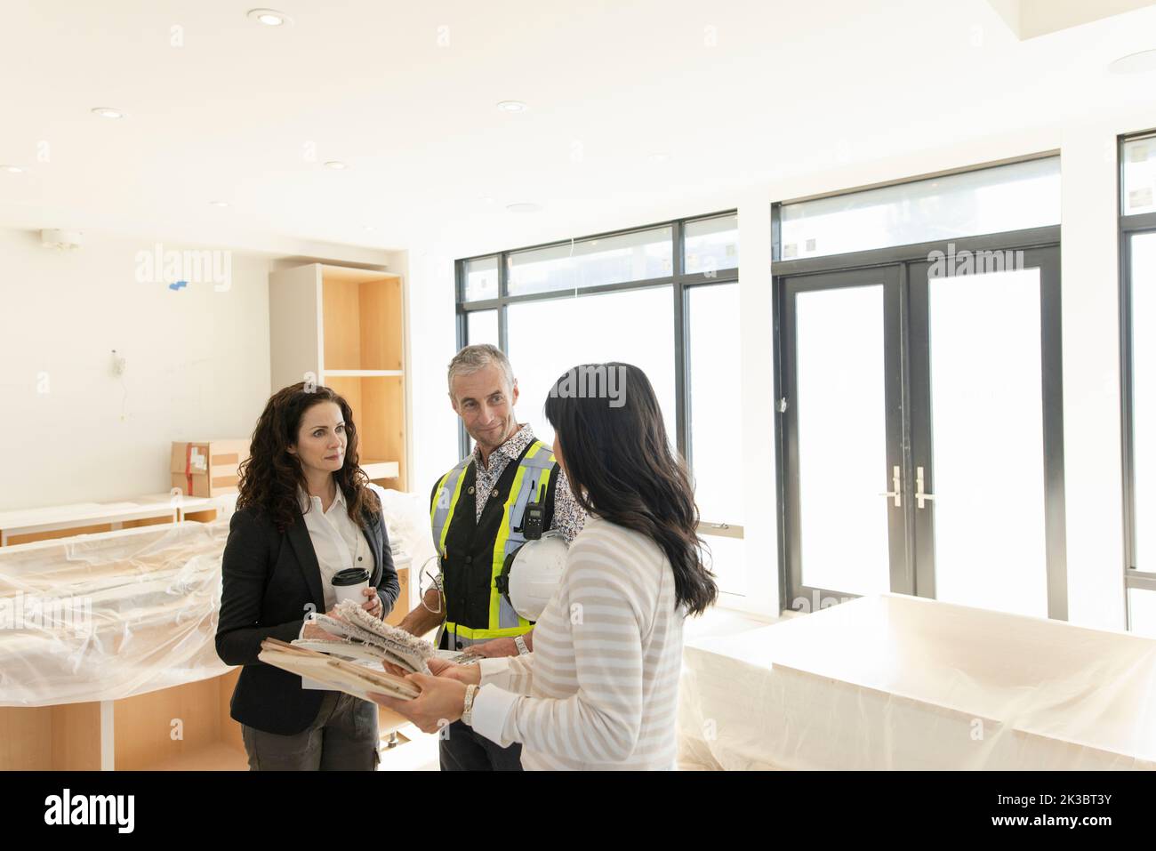 Architect and interior designers planning in house under construction ...