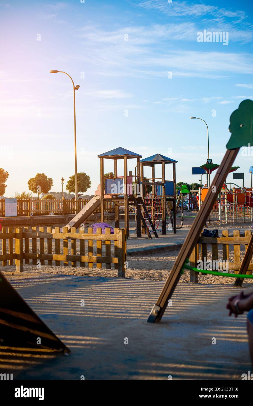 Public kids playground in Spain made of wood and plastic at sunset ...