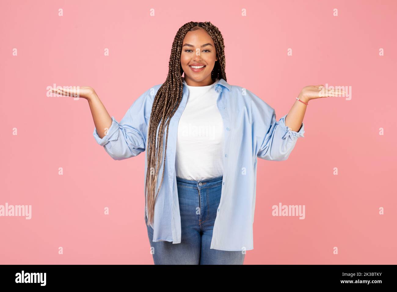 Plus Size Black Woman Holding Invisible Objects Over Pink Background ...