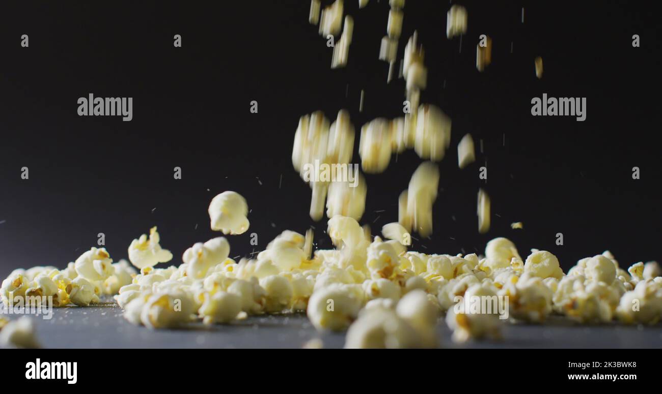 Image of close up of popcorn falling on black background Stock Photo ...