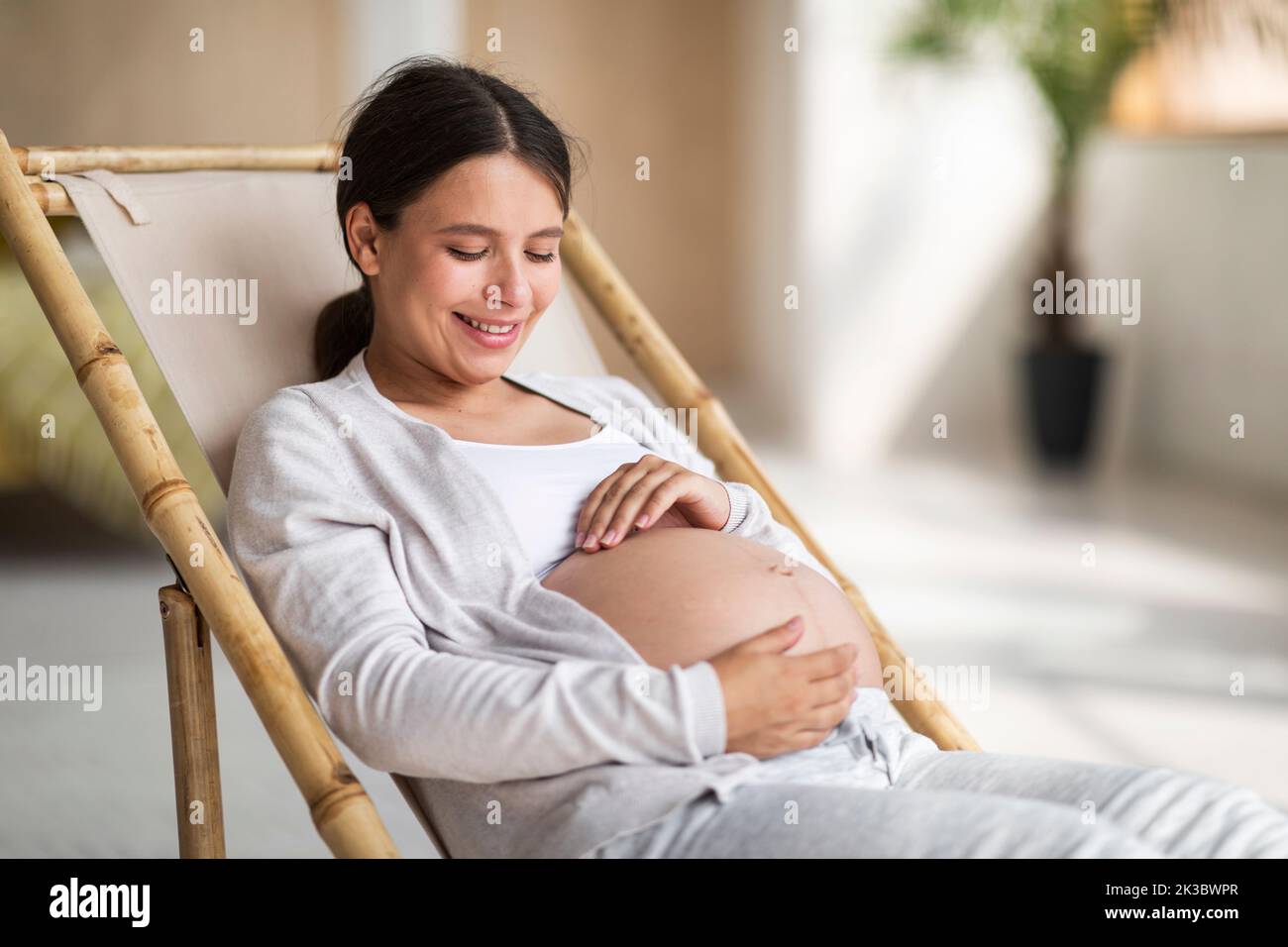 Happy Expectation. Beautiful Young Pregnant Woman Embracing Her Belly ...