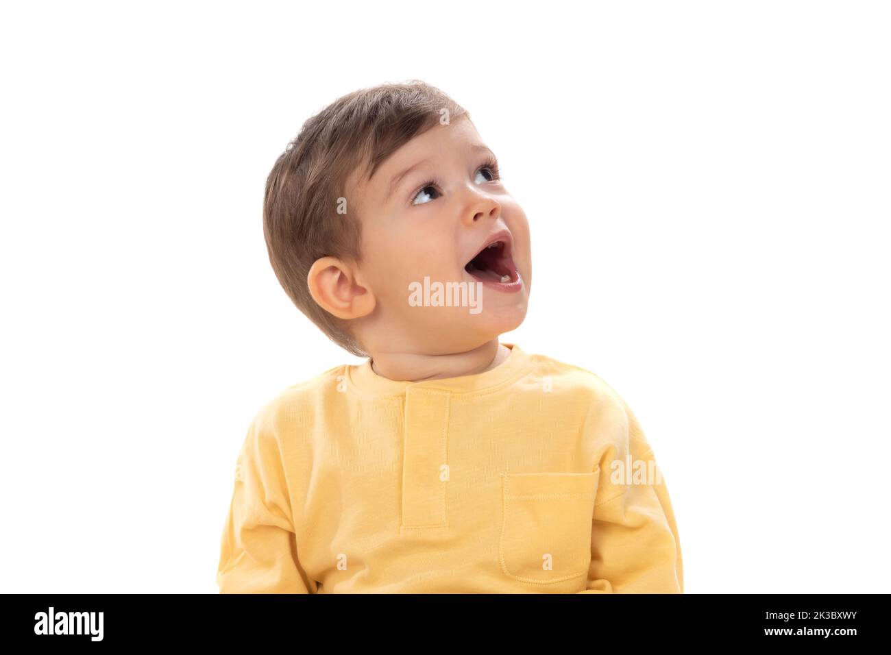 Pensive happy baby looking up isolated on la white background Stock ...