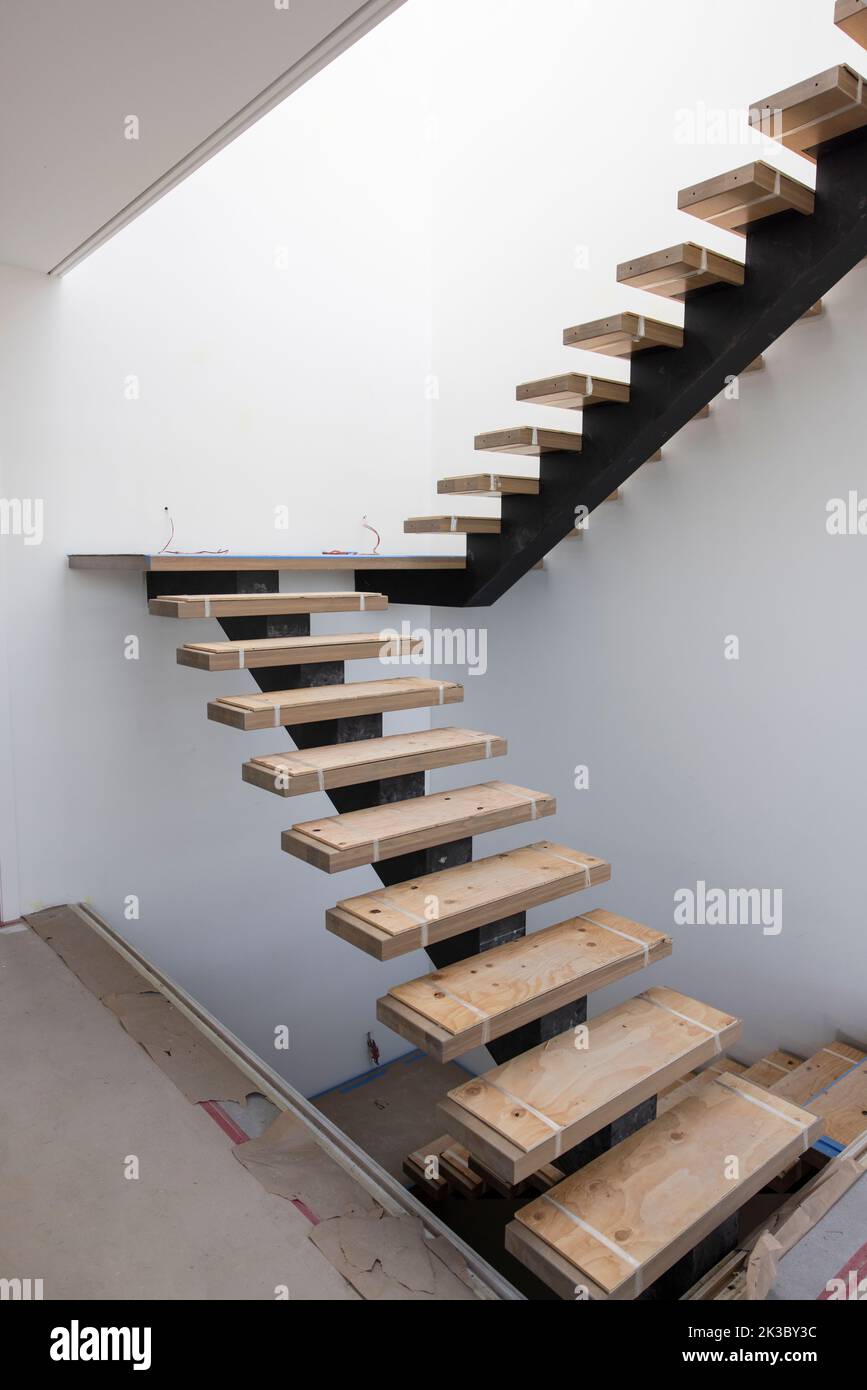 Modern floating stairs in house under construction Stock Photo - Alamy
