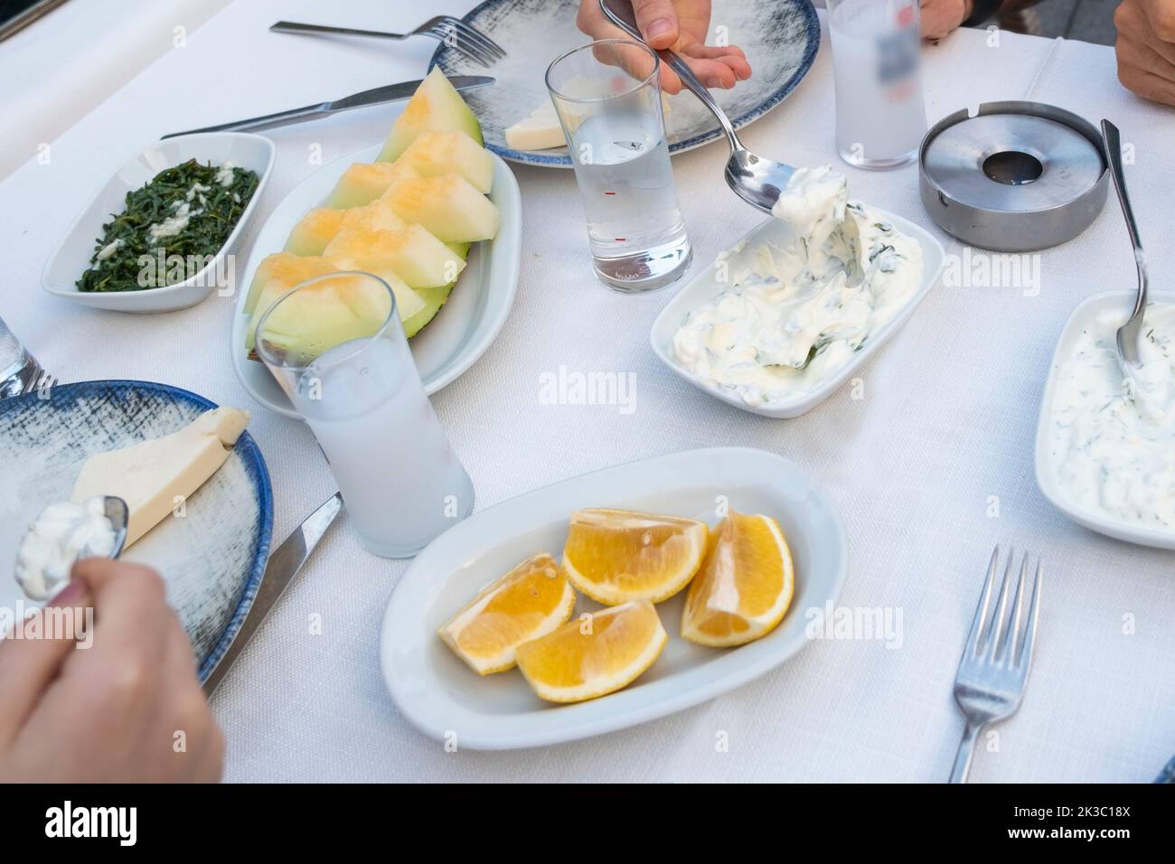 Turkish Raki table with melon, lemon and appetizer, traditional Turkish ...