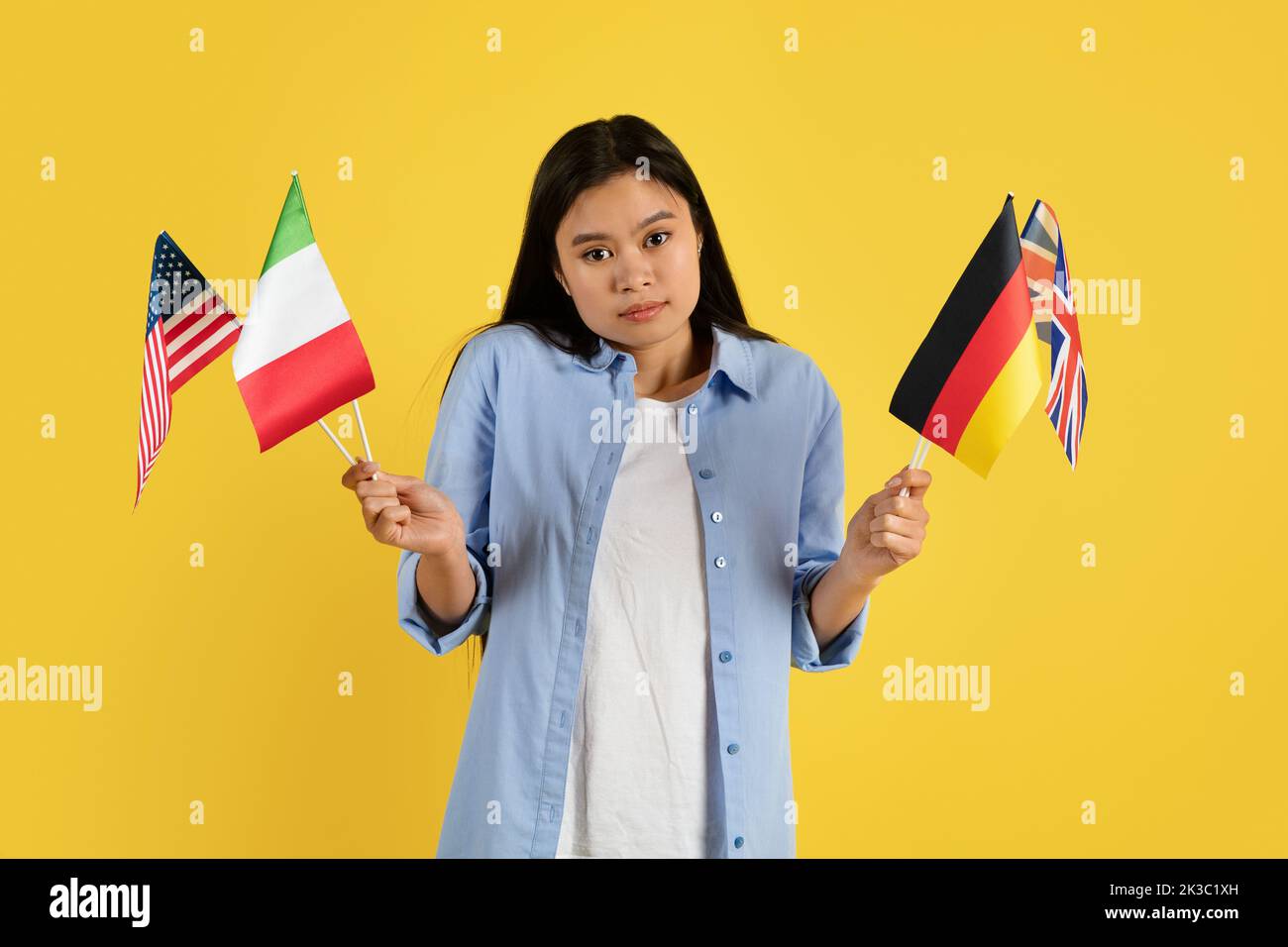 Sad confused young chinese female student in casual with many different ...