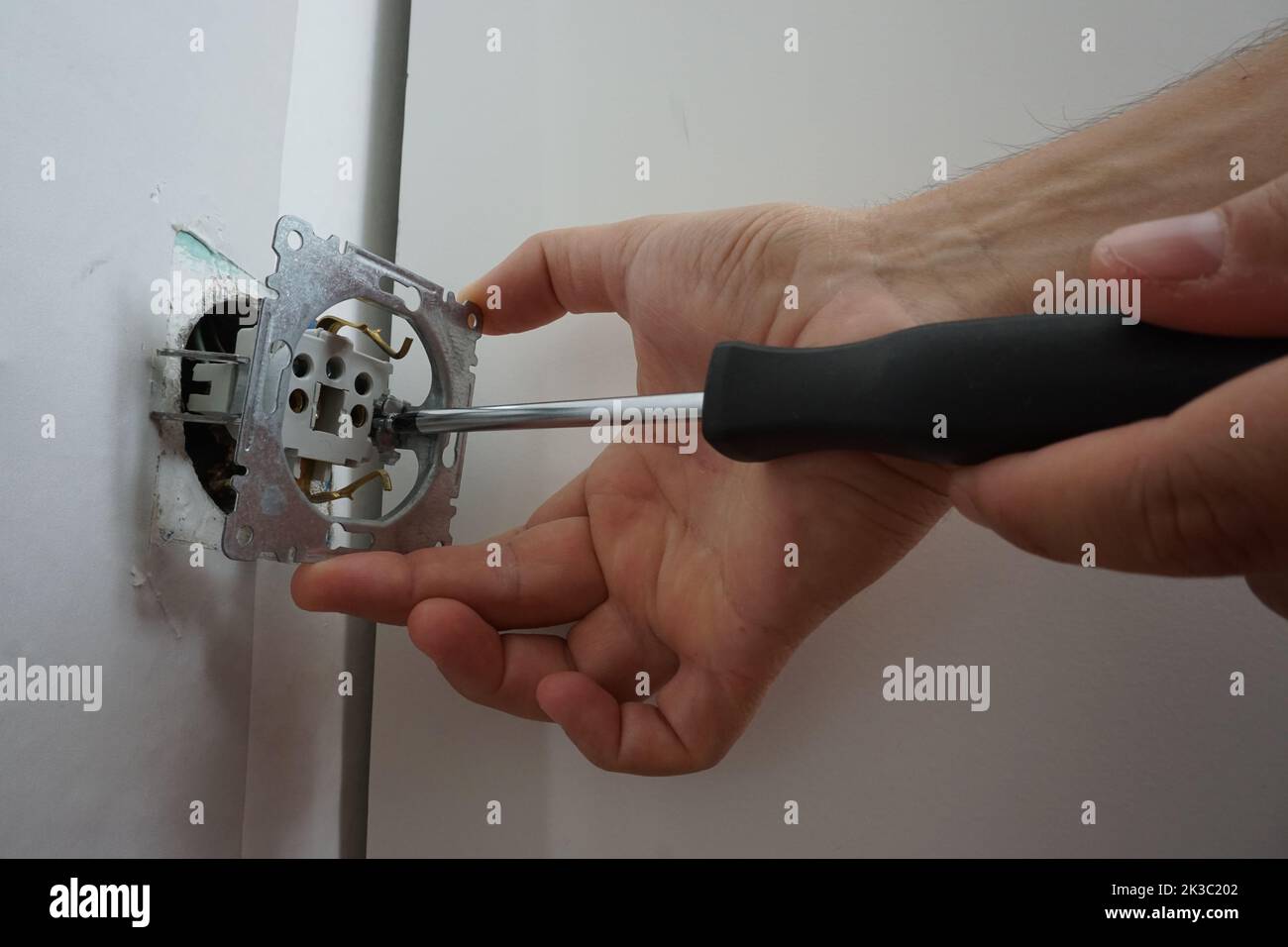 male hand repairing the socket Stock Photo - Alamy
