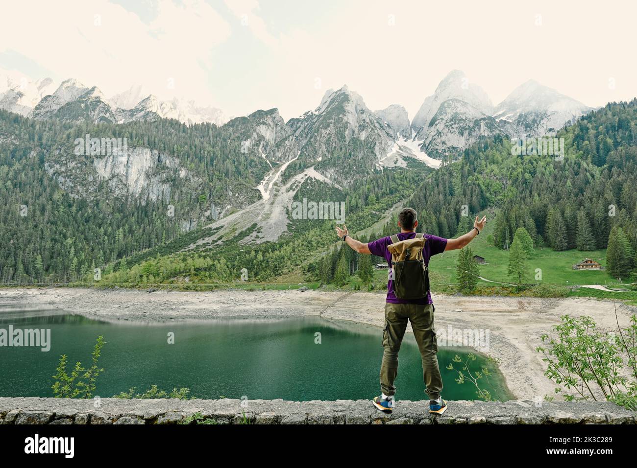 Back of man with backpack against lake and mountains at Vorderer ...