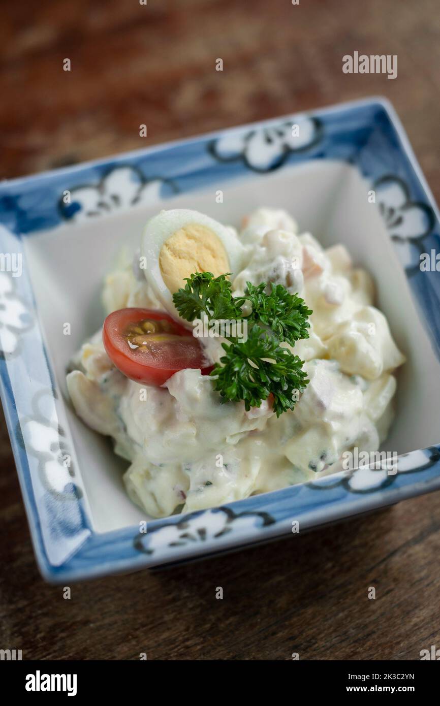 potato and egg salad Ensalada Rusa tapas in rustic spanish restaurant ...