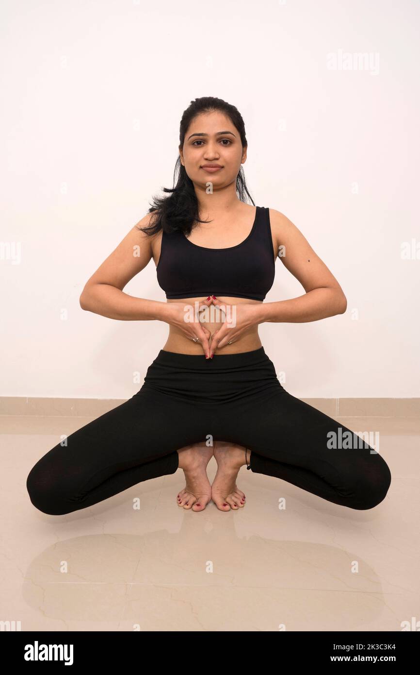 Girl doing gomukhasana or cow pose for strengthening knees, Yoga Asana ...