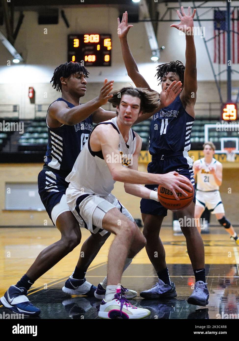 A vertical of athletic basketball players competing for the ball ...