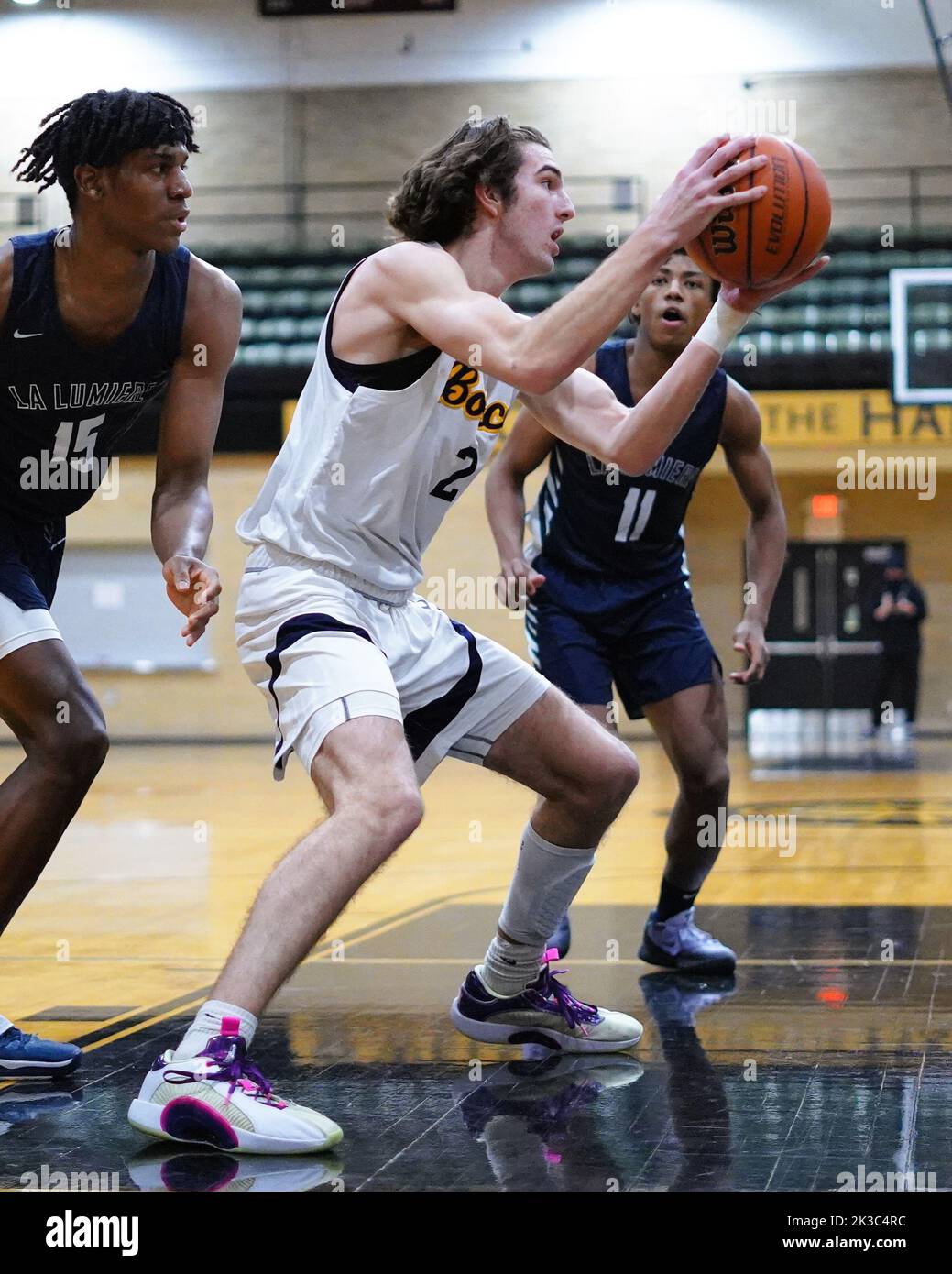 A vertical of athletic basketball players competing for the ball ...