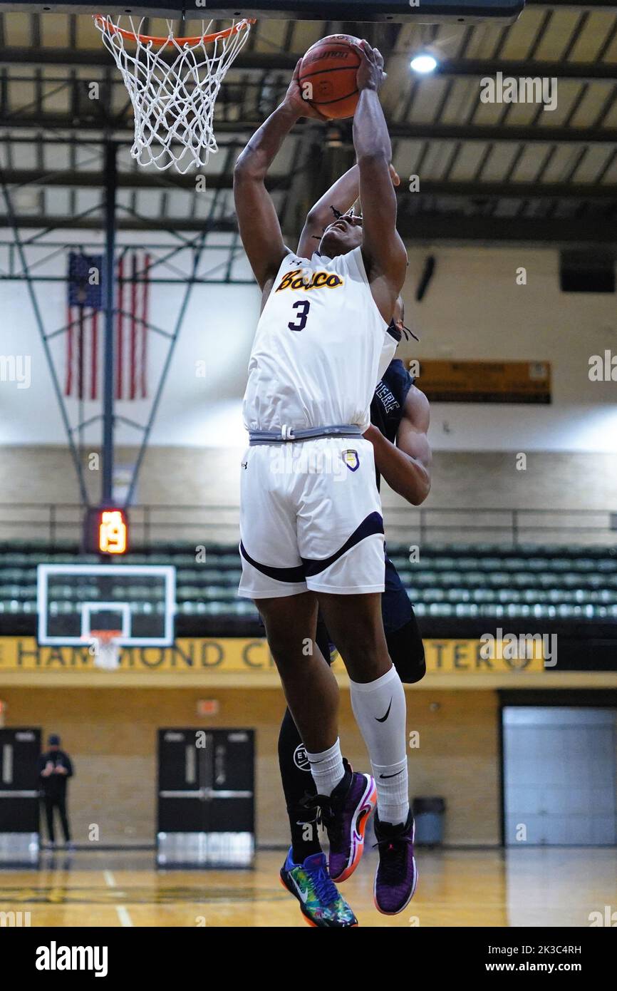 A vertical of a black athletic basketball player shooting the ball in ...