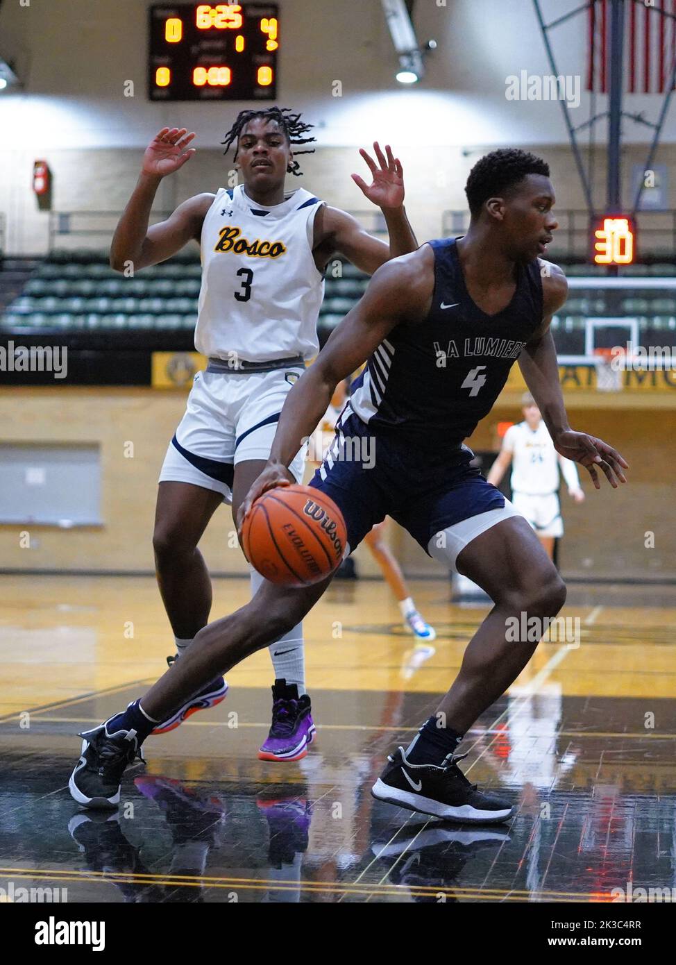 A vertical of athletic basketball players competing for the ball ...
